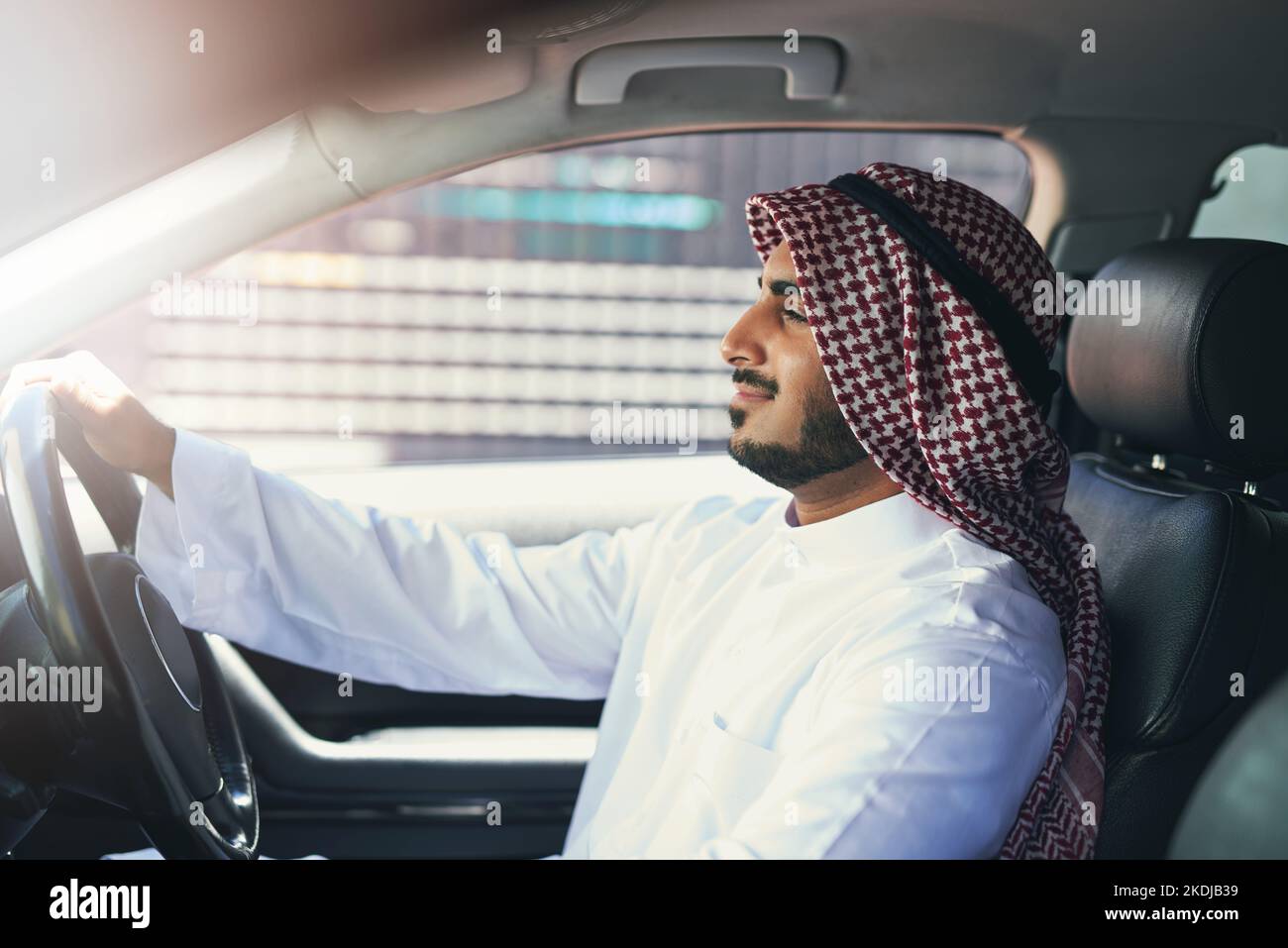 It pays to keep moving forward. a young muslim businessman driving a ...