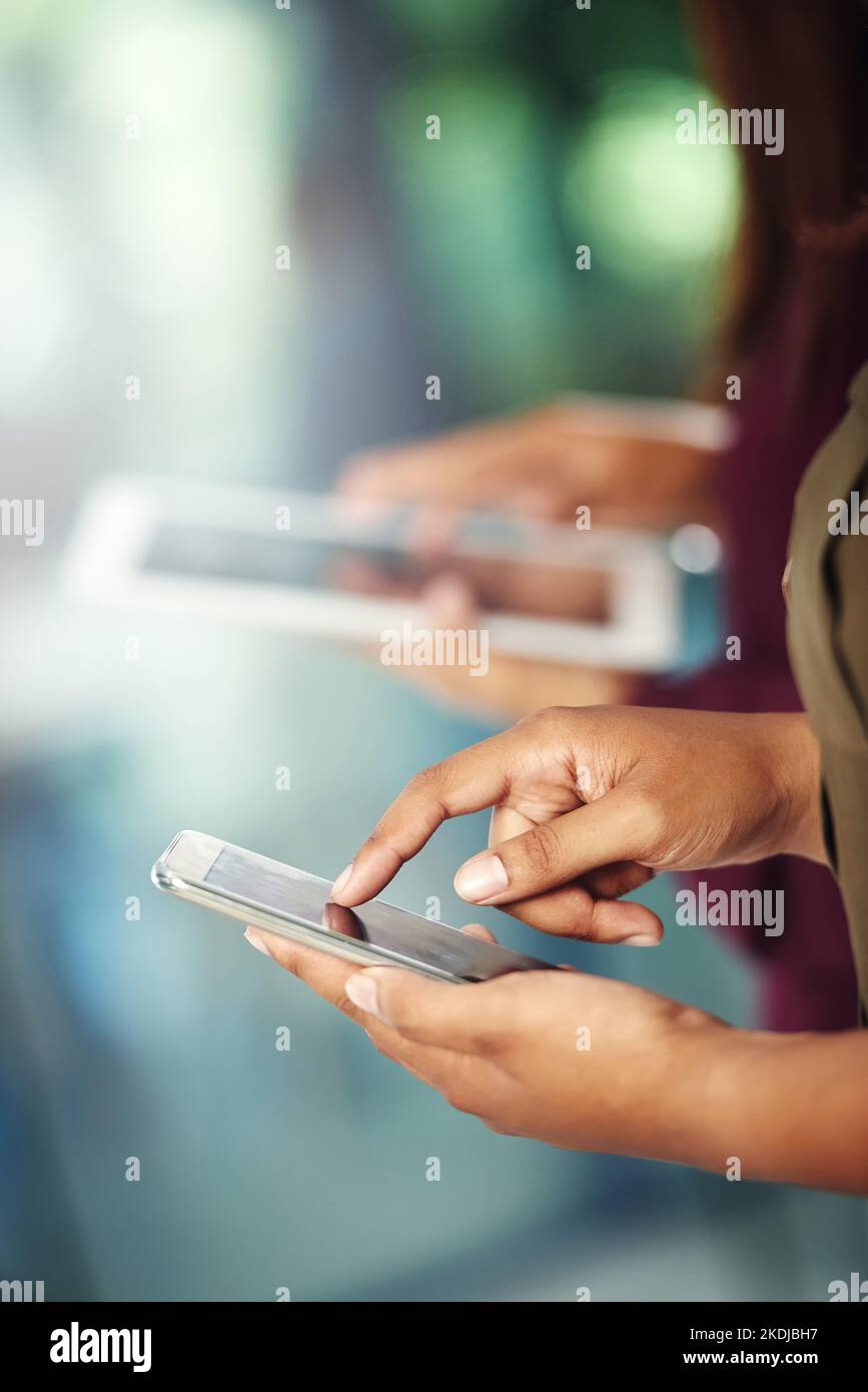 Staying connected. two unrecognisable people using their digital ...