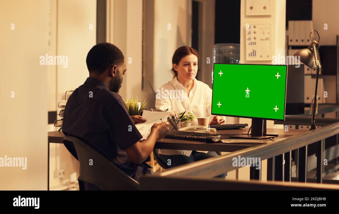African american man working with greenscreen on computer, analyzing ...