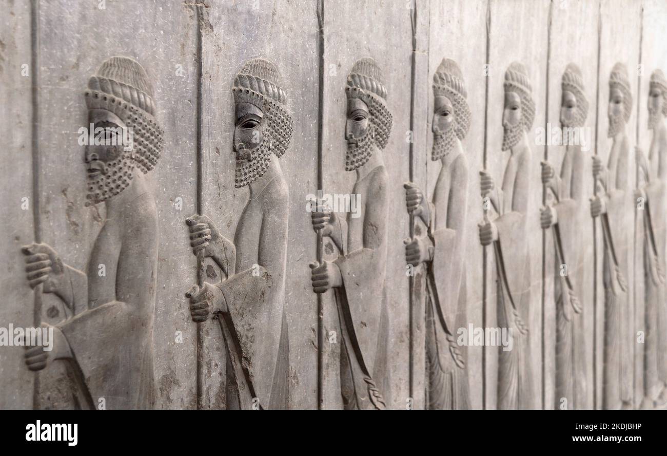 Ancient wall with bas-relief with assyrian warriors with spears ...