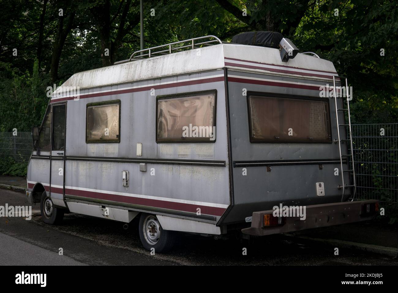 old vintage camper van parked on the street from behind Stock Photo - Alamy