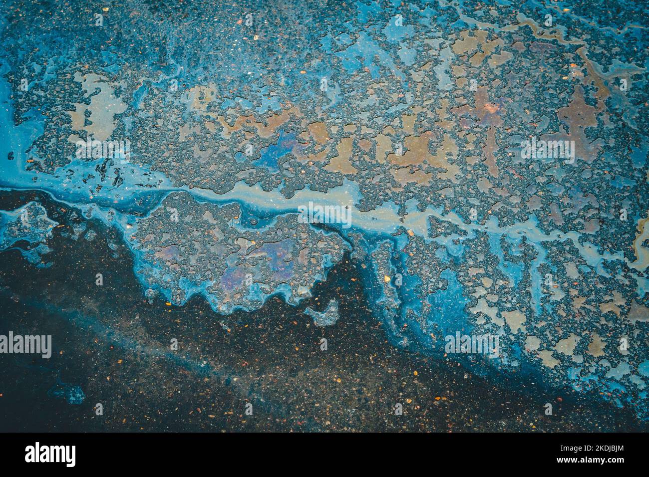 Colorful oil spill on wet pavement Stock Photo - Alamy