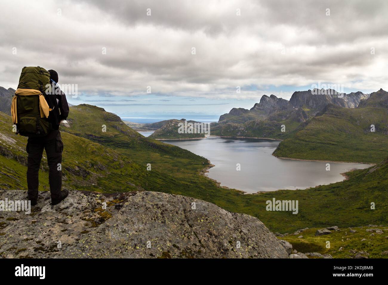 one single hiker with big backpack on the top of the mountain with a ...