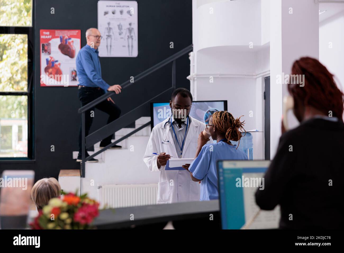 Physician doctor talking with assistant discussing patient symptoms ...