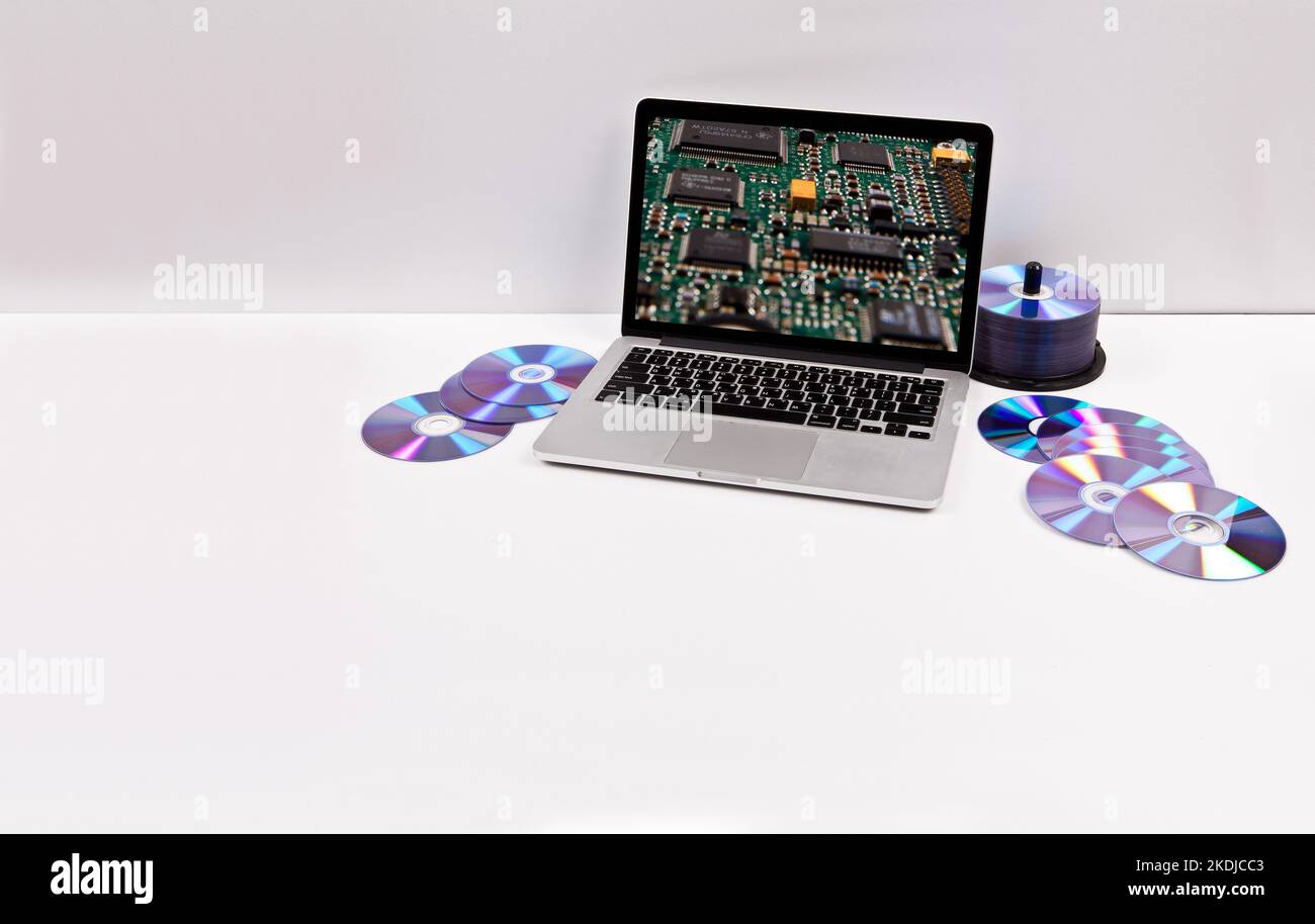 Laptop and CD isolated on white background. communication network ...