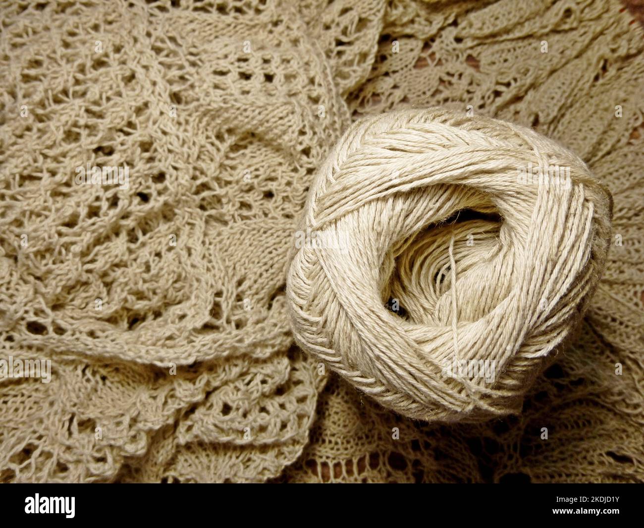Linen yarn in a skein, a knitted openwork fabric. Close-up. The texture ...