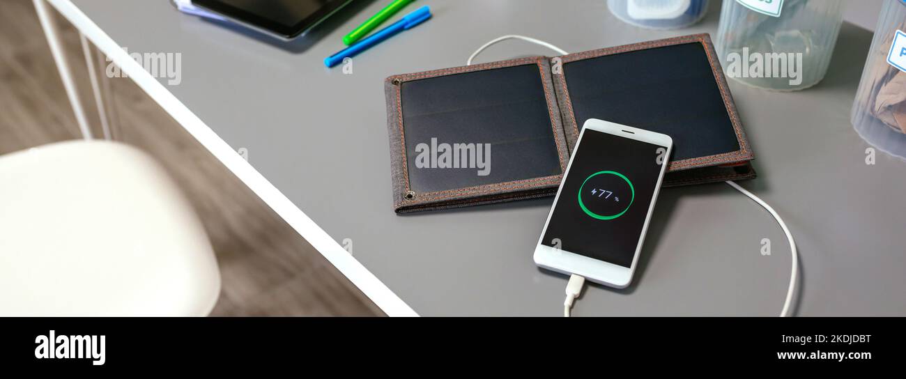 Mobile phone charging with portable solar panel bins over desk in ...
