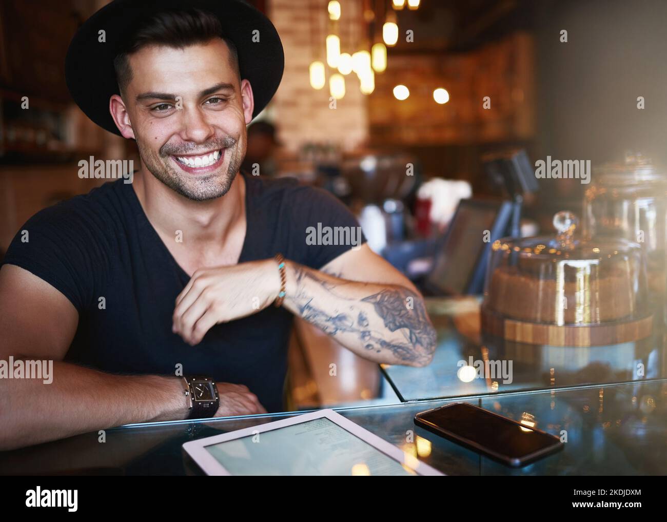 Committed to the culture of coffee. a handsome young man working behind ...