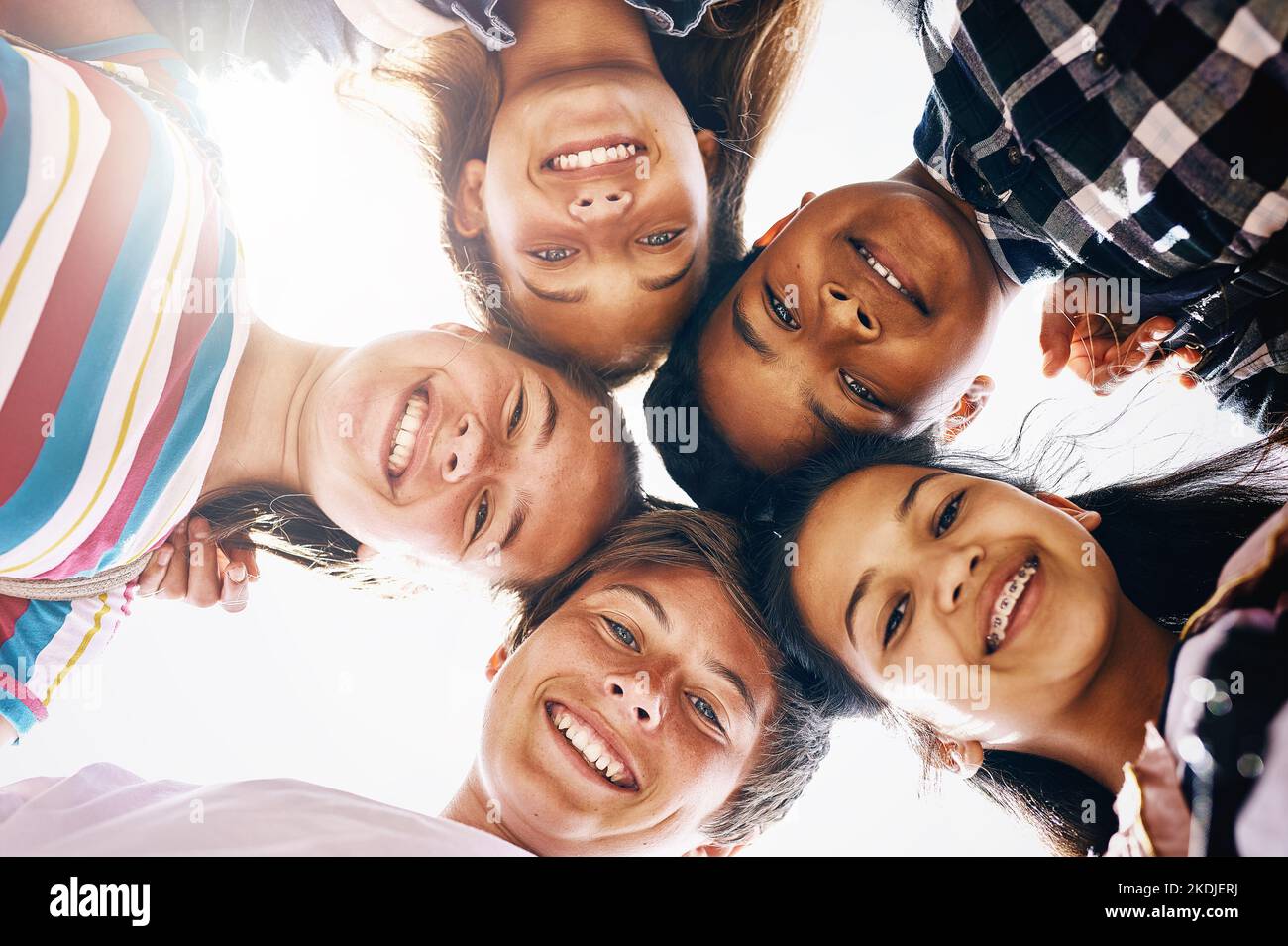 They always find a reason to smile. Low angle portrait of a group of diverse schoolchildren ...
