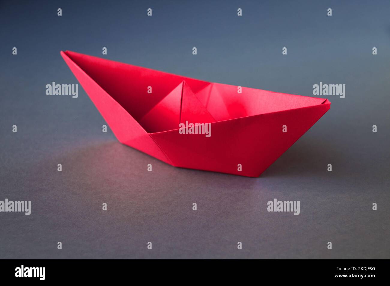 Red paper boat origami isolated on a blank grey background Stock Photo ...