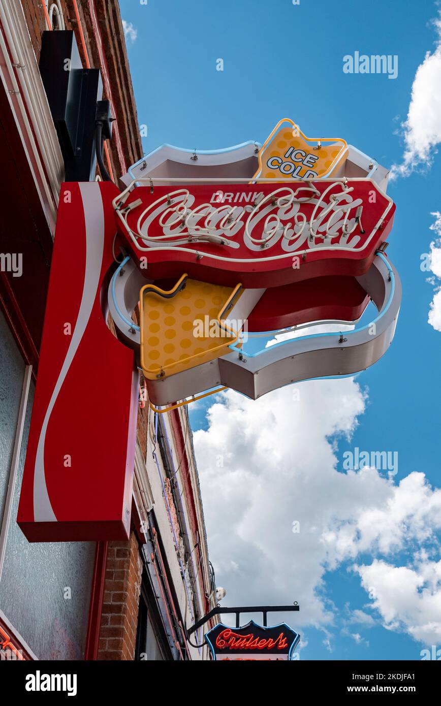 Electric signboard with arrow symbol on shop in old city during summer ...
