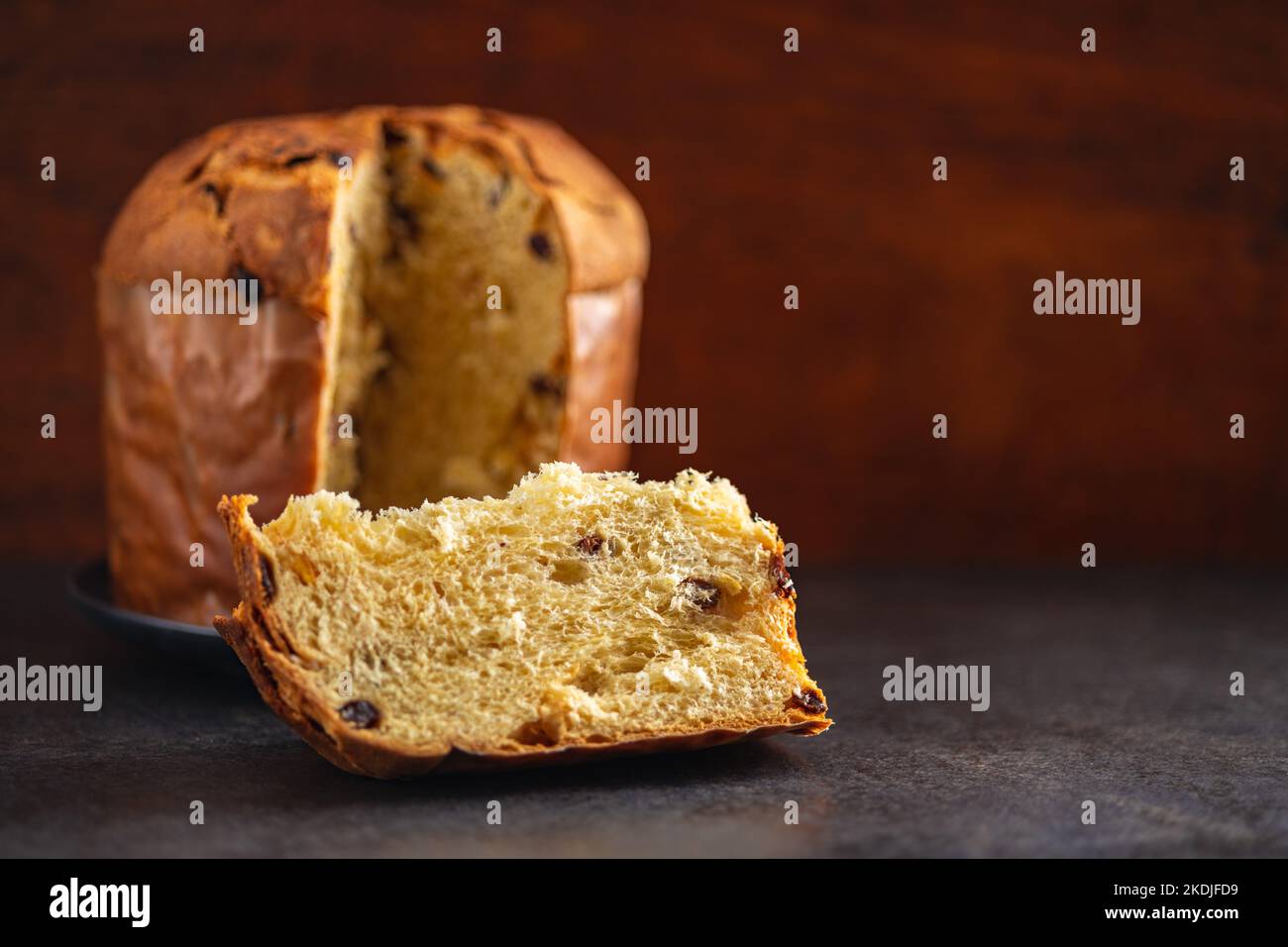 Panettone Christmas Cake. Italian sweet bread on the black kichen table ...