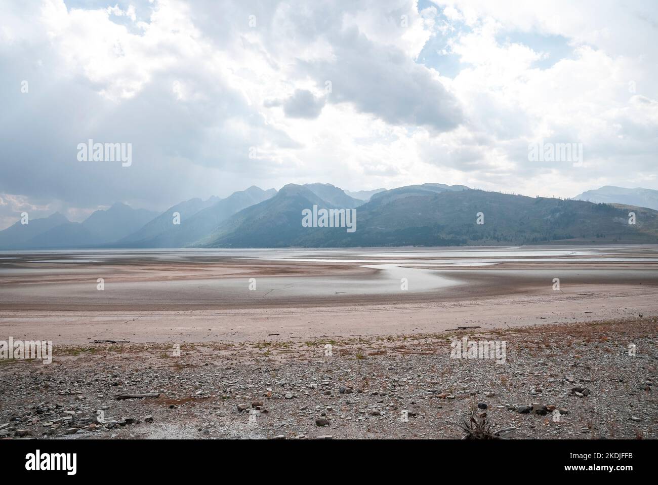 Scenic view of lake and mountains in valley with cloudy sky in ...