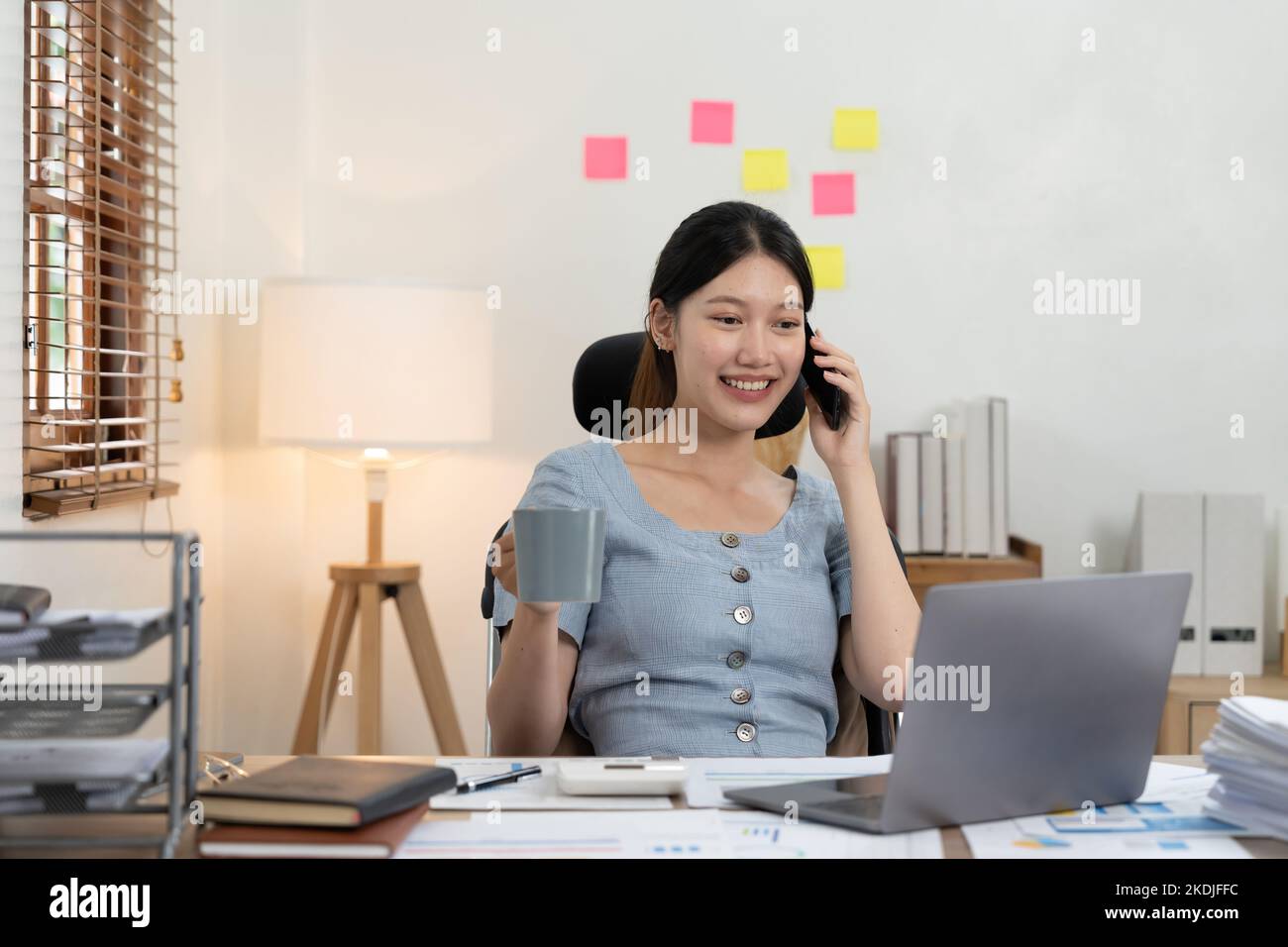 Young accountant with smartphone to call marketing consultants and ...