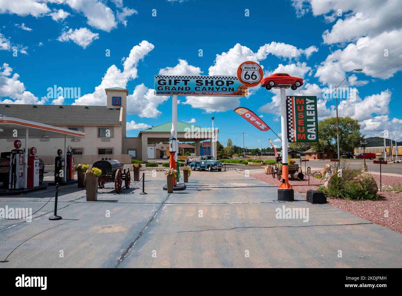 Signboards by gas station at Route 66 in city with blue sky in ...