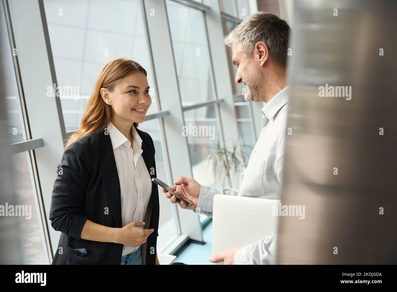 Employees of a financial company communicate at the window Stock Photo ...