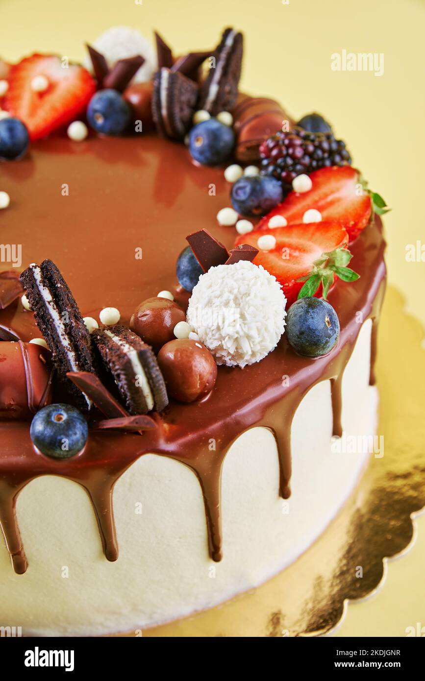 Birthday cake on yellow background. Close up of cake decorated with ...