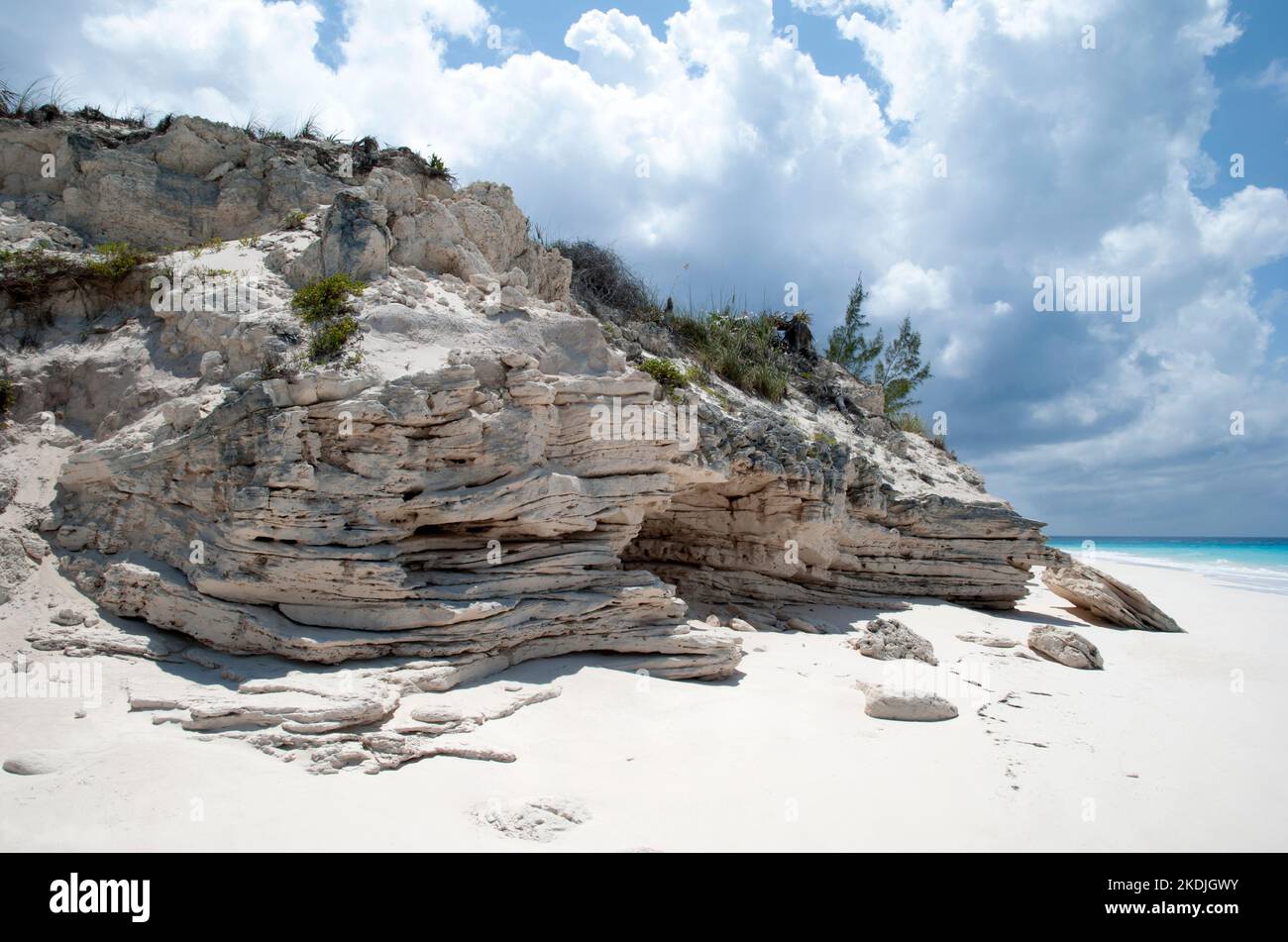 The eroded rock formation and a sandy empty beach on Half Moon Cay ...
