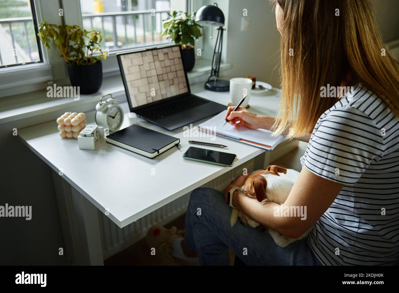Home office workplace with laptop. Woman working remotely from home ...