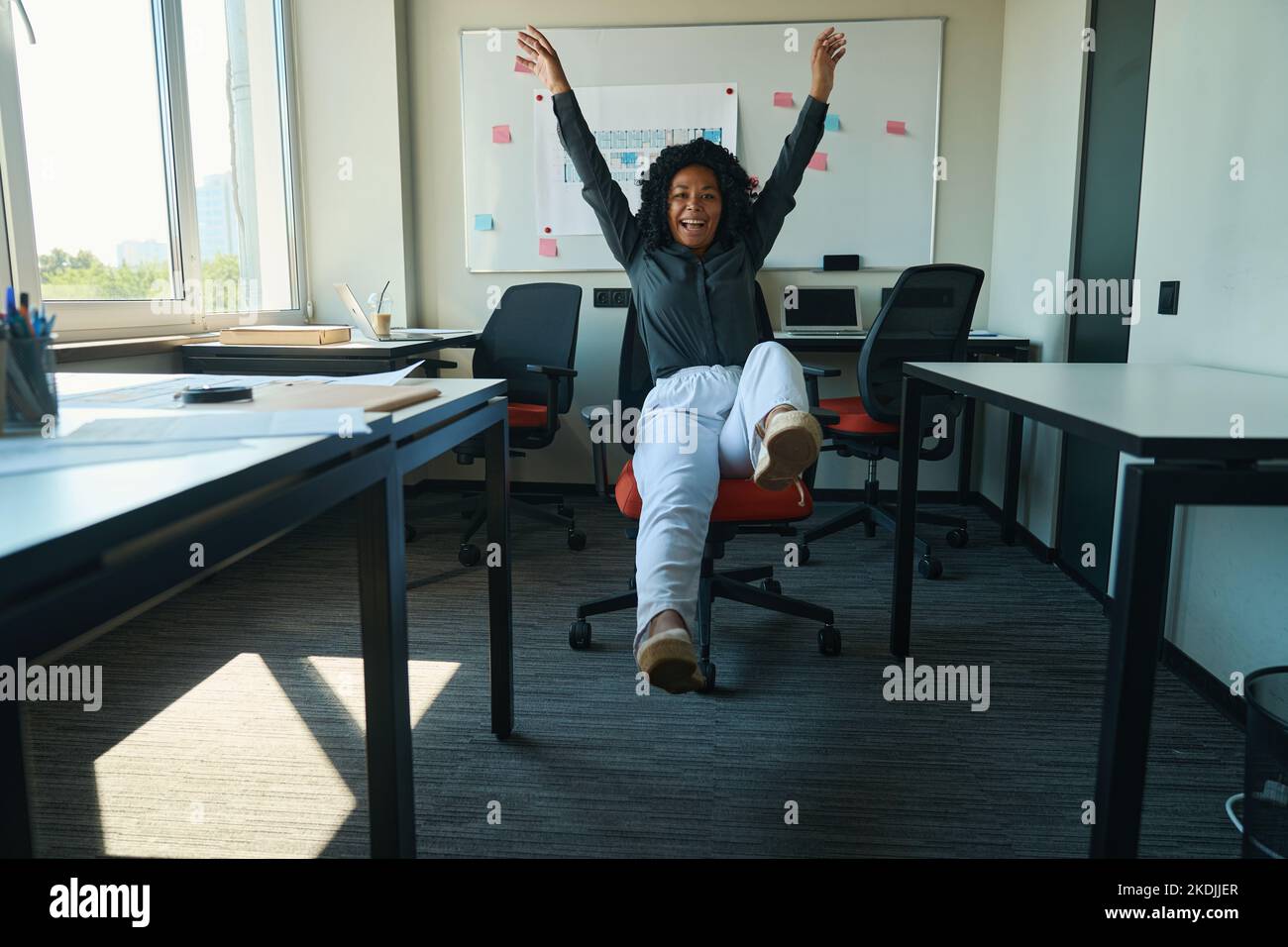 Female rolls around the office of an armchair Stock Photo - Alamy