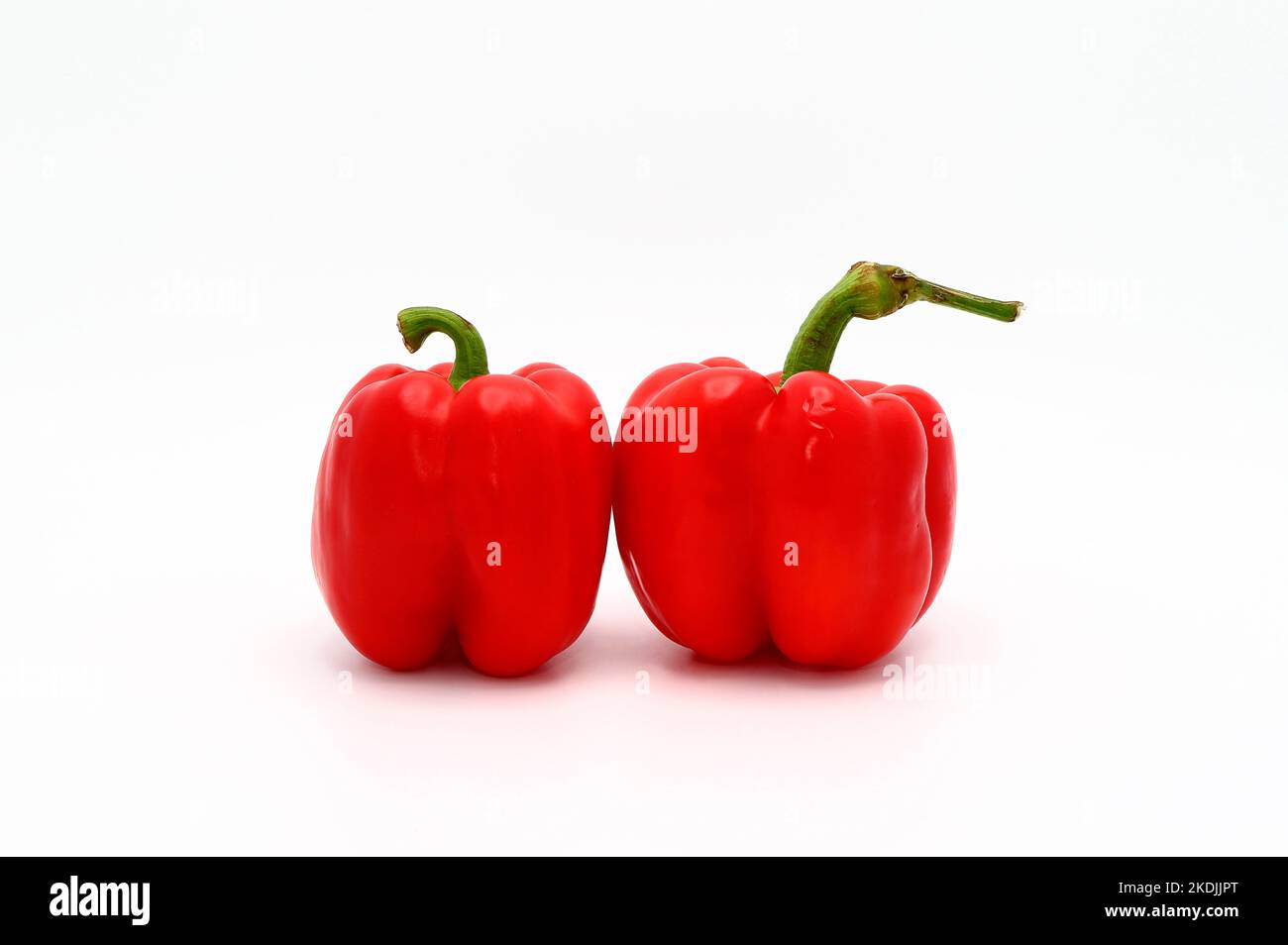 Two red ripe sweet peppers on a light background. Natural produc Stock ...