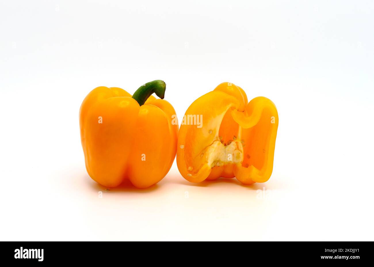 Sweet yellow pepper whole and in a cut on a light background. Natural ...
