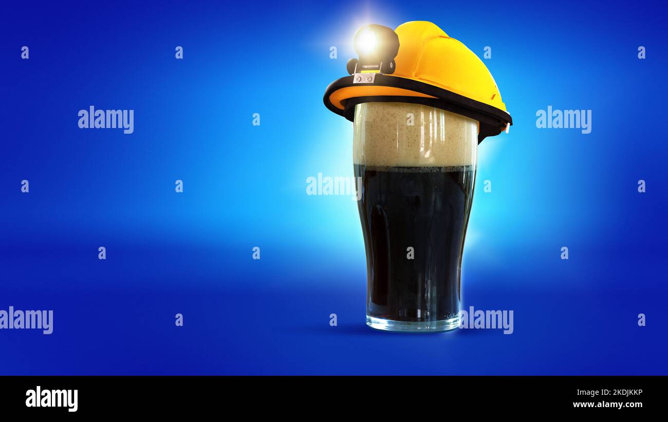 Builder. Mug of frothy dark beer wearing protective helmet isolated ...