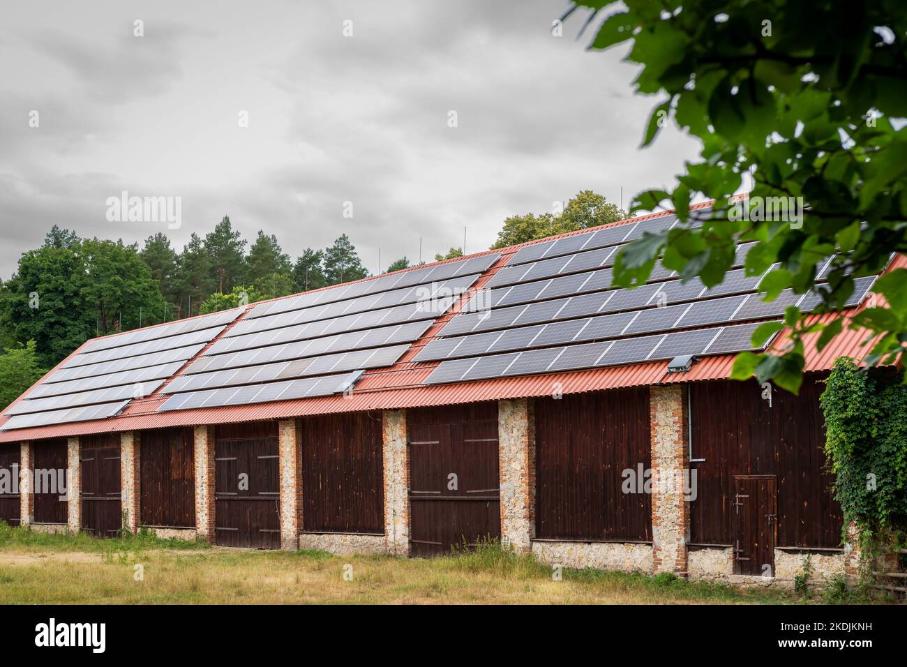 A huge brick barn with solar panels on the roof. Horse stud in ...