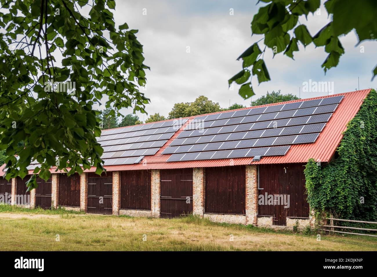 A huge brick barn with solar panels on the roof. Horse stud in ...