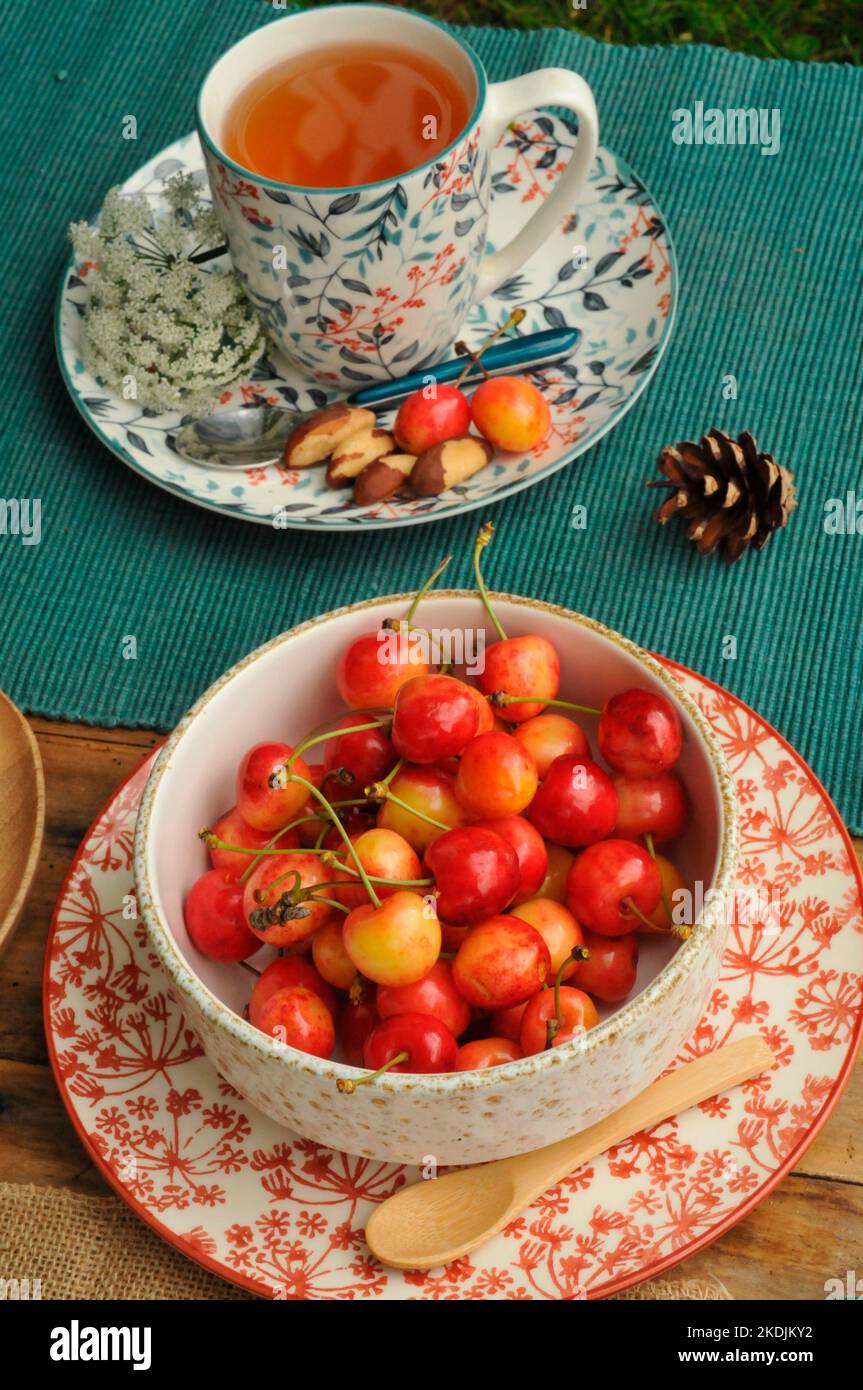 Lime infusion in plant-patterned tableware, Napoleon cherries and ...