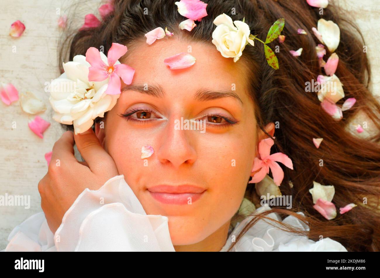 Beauty through plants, roses and oleander flowers on the face of a ...