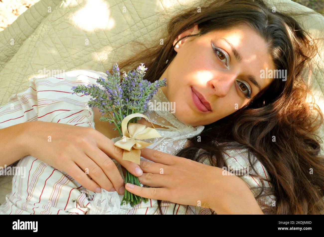 Bunch of lavender (Lavandula sp) in bloom on a woman at rest in a ...