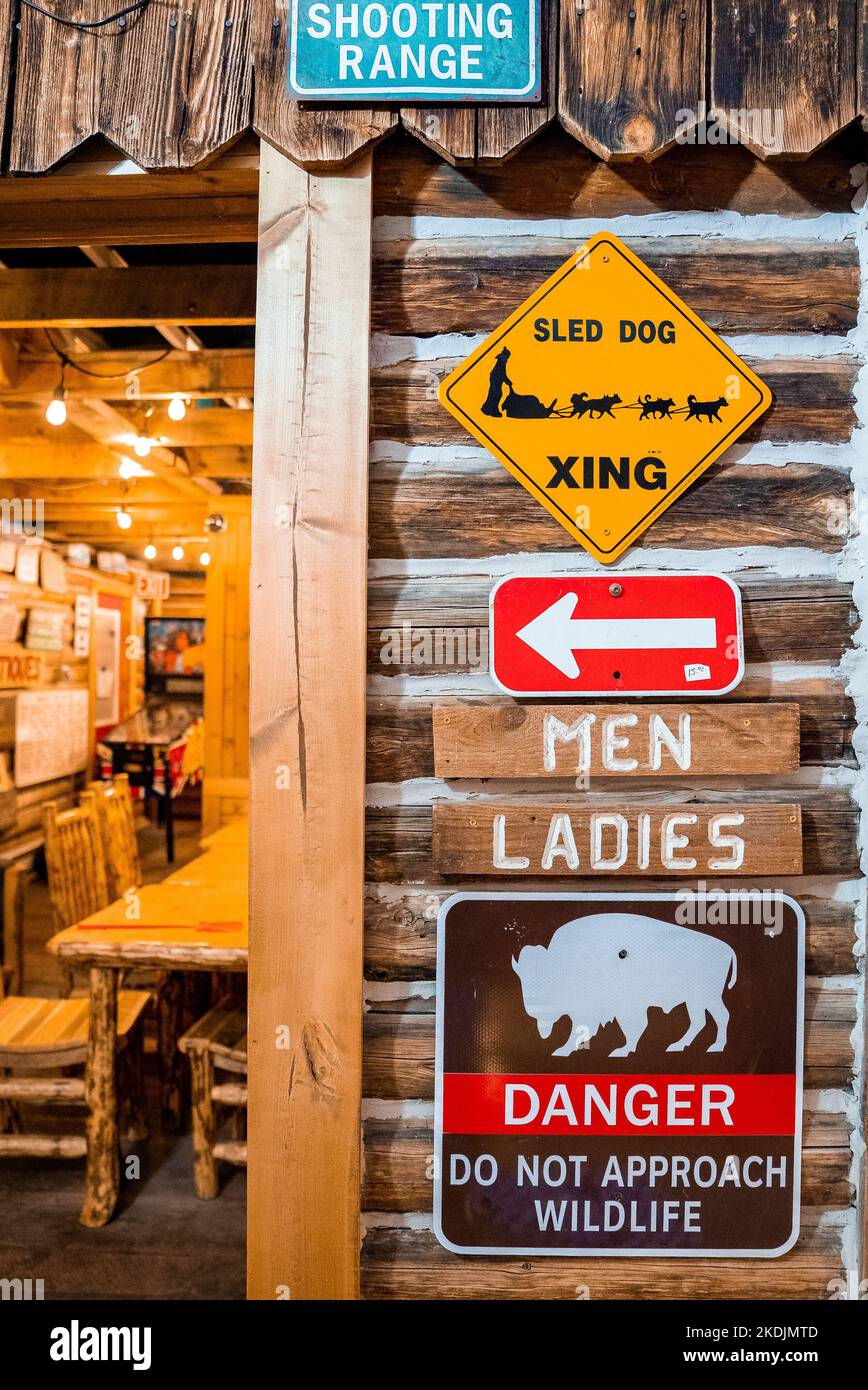 Various signboards on wooden wall of restaurant at Yellowstone national ...