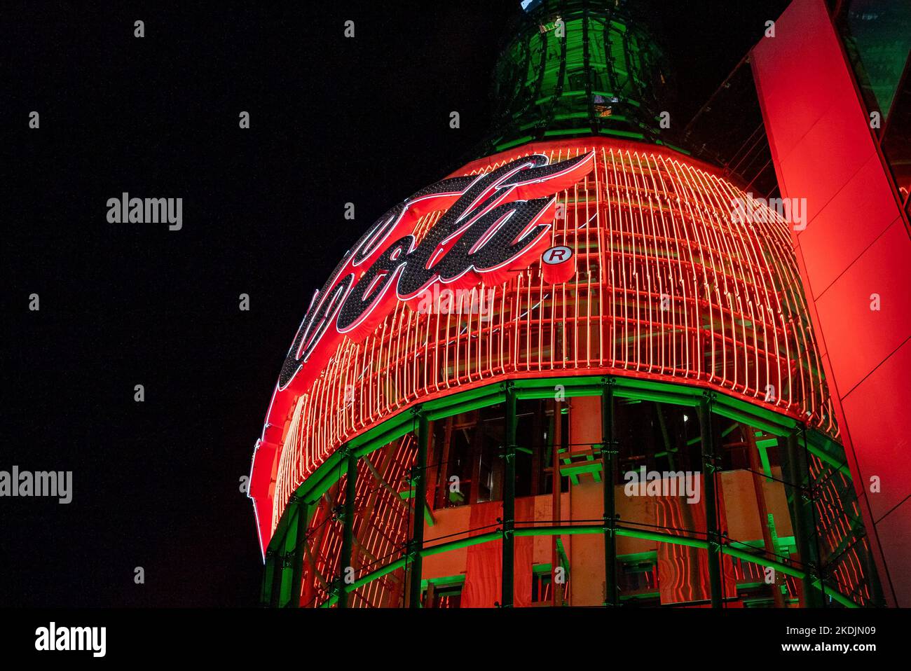 Illuminated Coca-Cola store in famous city with sky in background ...