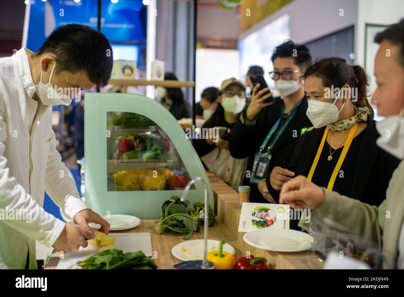 Visitors are trying raw edible corn in Bayer booth, Shanghai, China, 6 ...