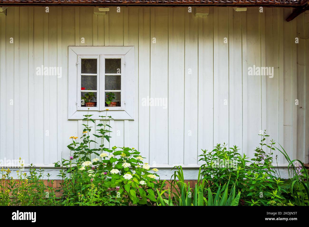 Front view of the facade of the old house. White painted boards. A ...