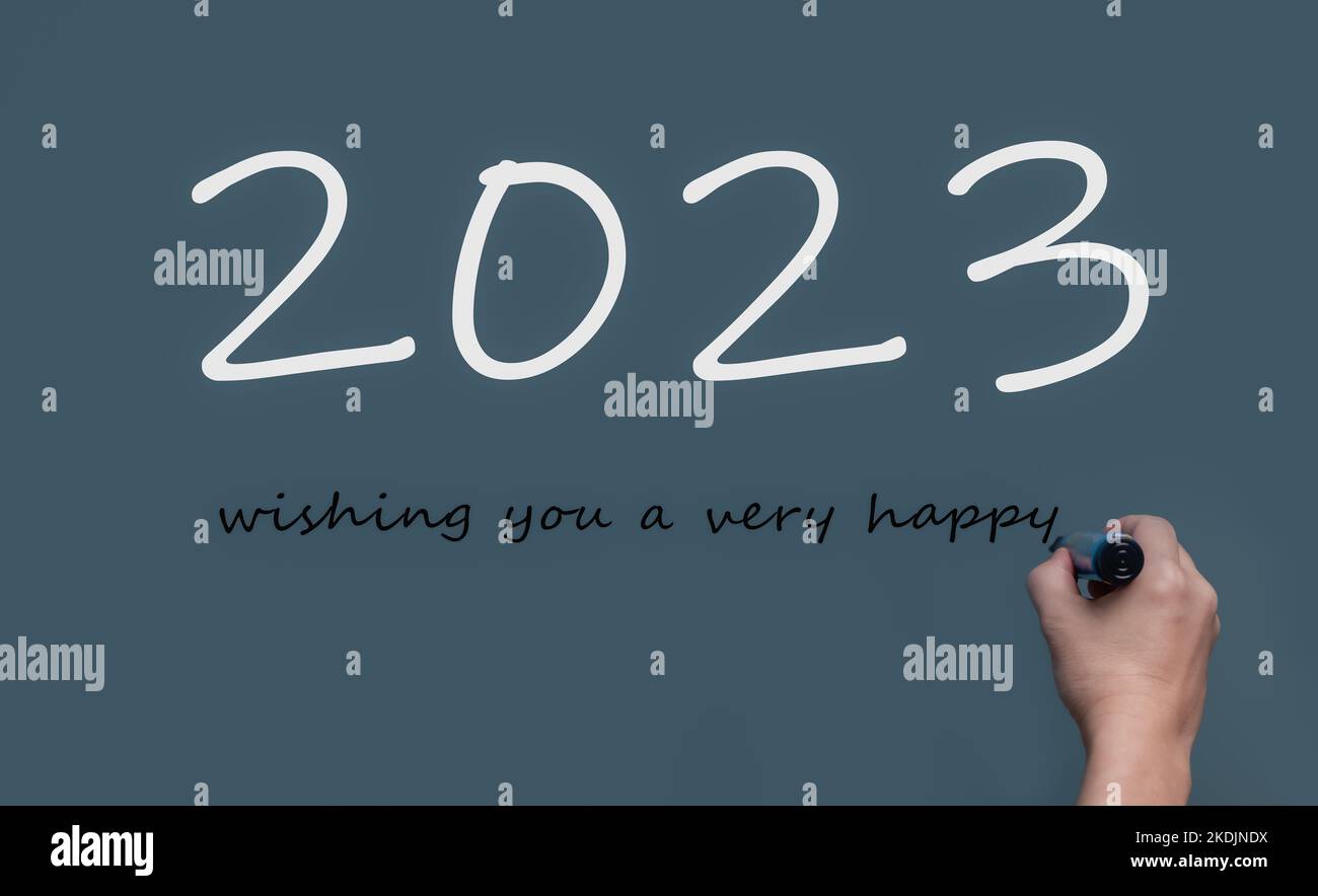 Human hand writhing 2023 Happy New Year and wishing you a very happy ...