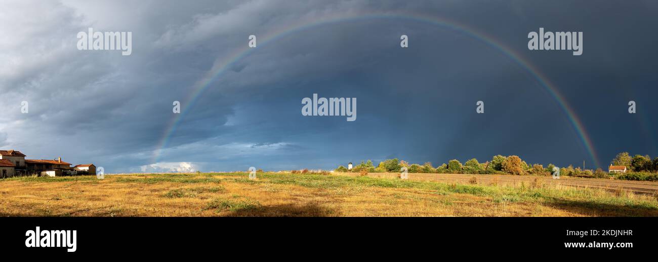 Rainbow on countryside in France Stock Photo - Alamy