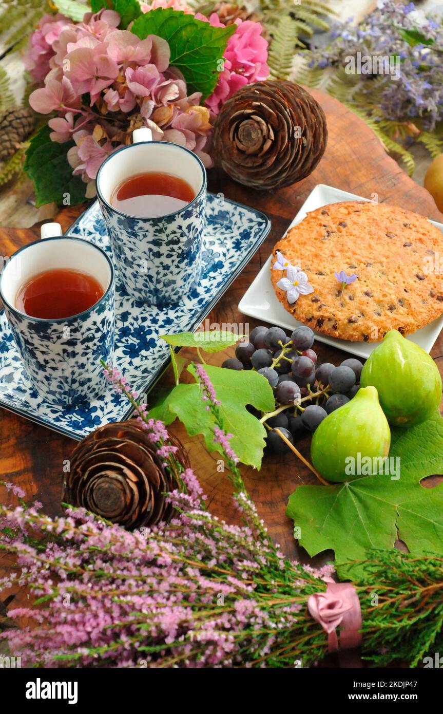 Snack time in the garden: Biscuit, white figs, black grapes, tea and ...