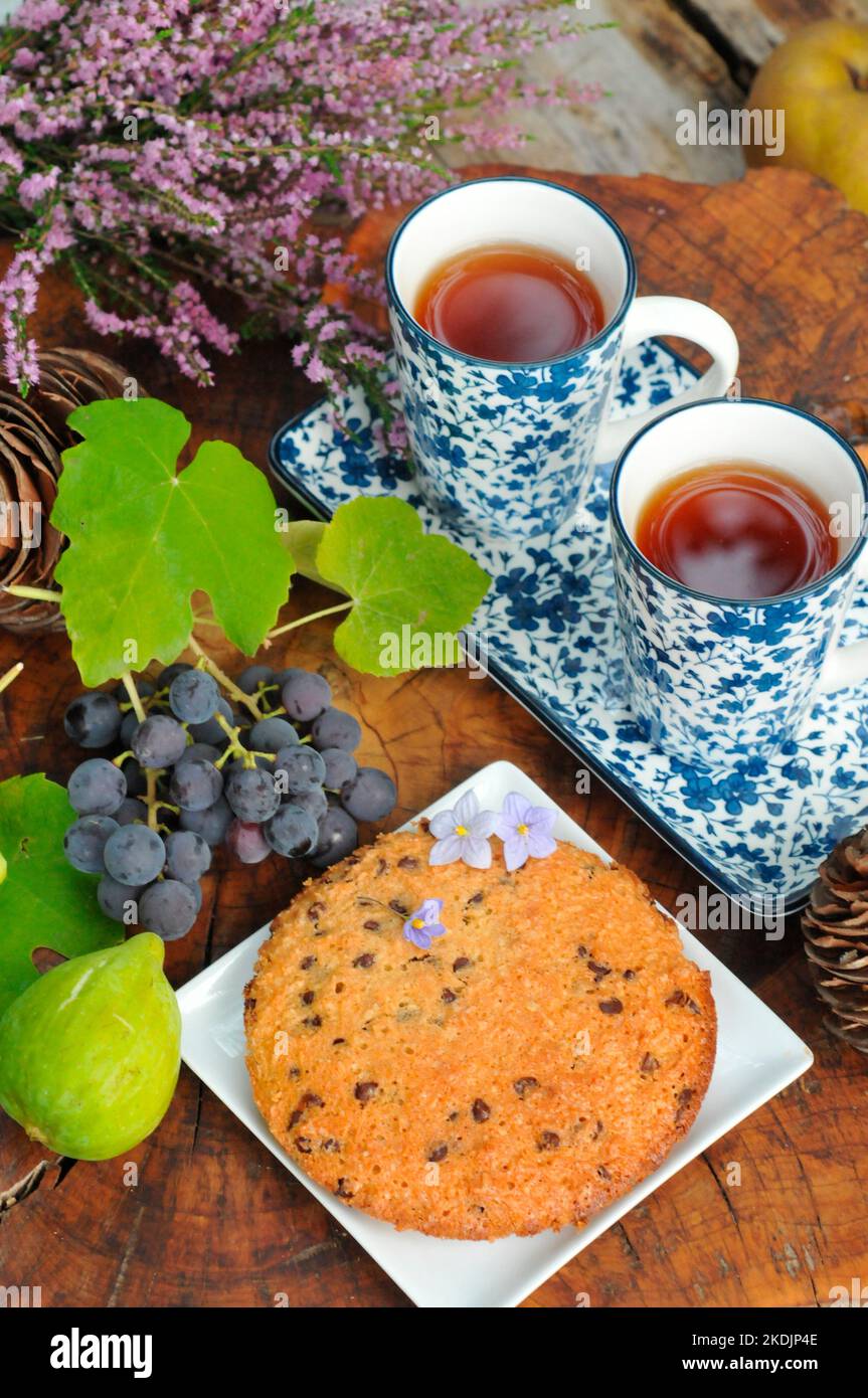 Snack time in the garden: Biscuit, white figs, black grapes, tea and ...