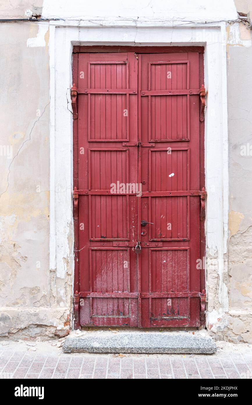 Big red front door. Destroyed building wall Stock Photo - Alamy