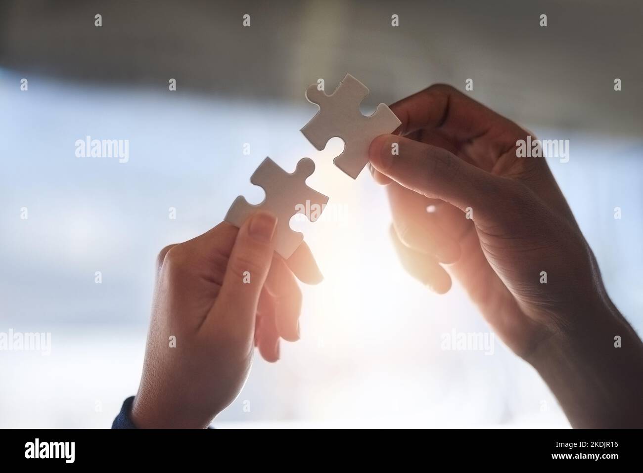 We go together. two unidentifiable friends holding up puzzle pieces ...