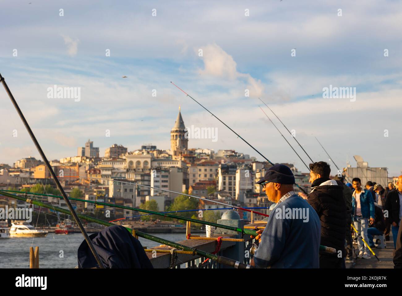 Citizens of Istanbul. Local people fishing with fishing rods on Galata ...