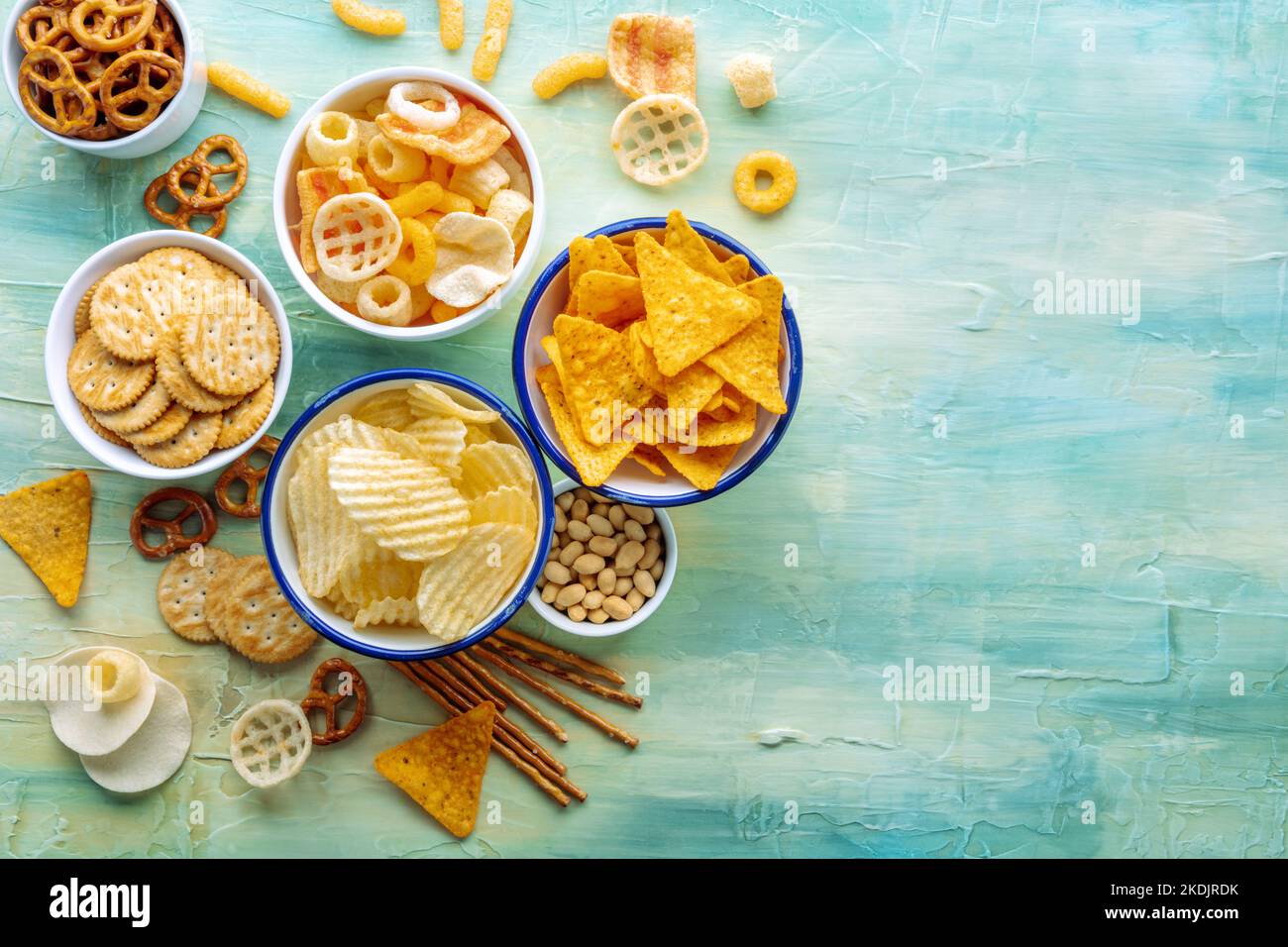 Salty snacks. Potato and tortilla chips, crackers and other appetizers ...