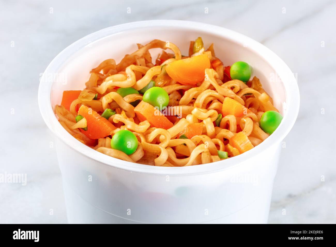 Ramen cup, instant soba noodles in a plastic cup with vegetables, a ...