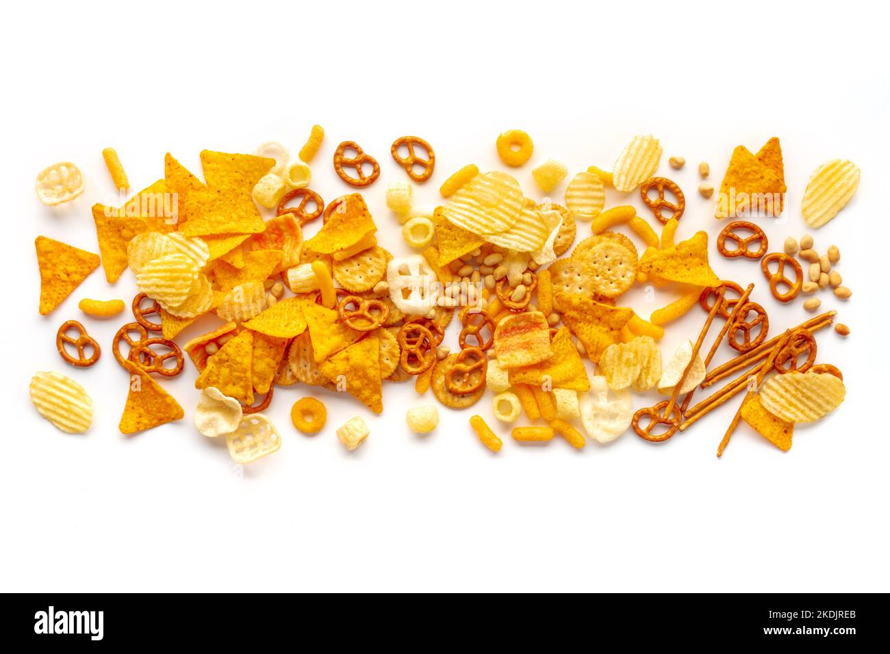 Salty snacks texture on a white background. Party food mix. Potato and ...