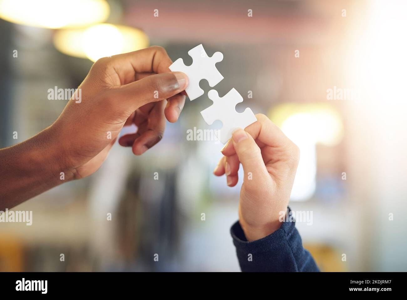 Two men holding puzzle pieces hi-res stock photography and images - Alamy