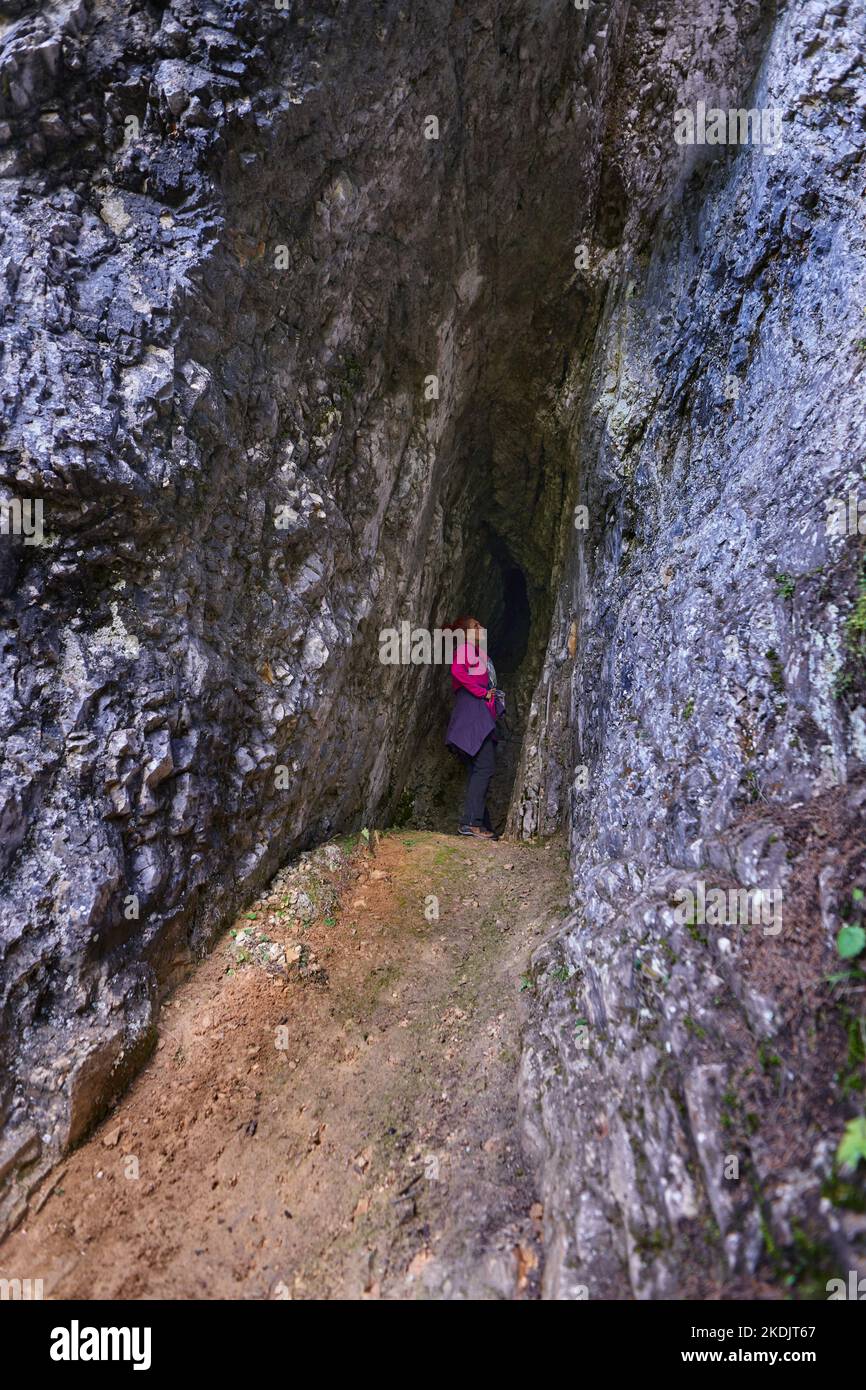 Woman hiker exploring a cave in the limestone mountains Stock Photo - Alamy