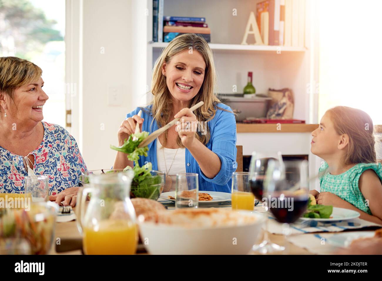 Sharing meals and smiles around the table. a multi generational family ...