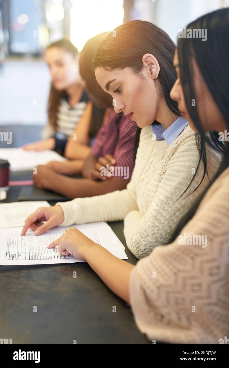 Figuring it out together. a group of young friends having a study session in a cafe Stock Photo ...
